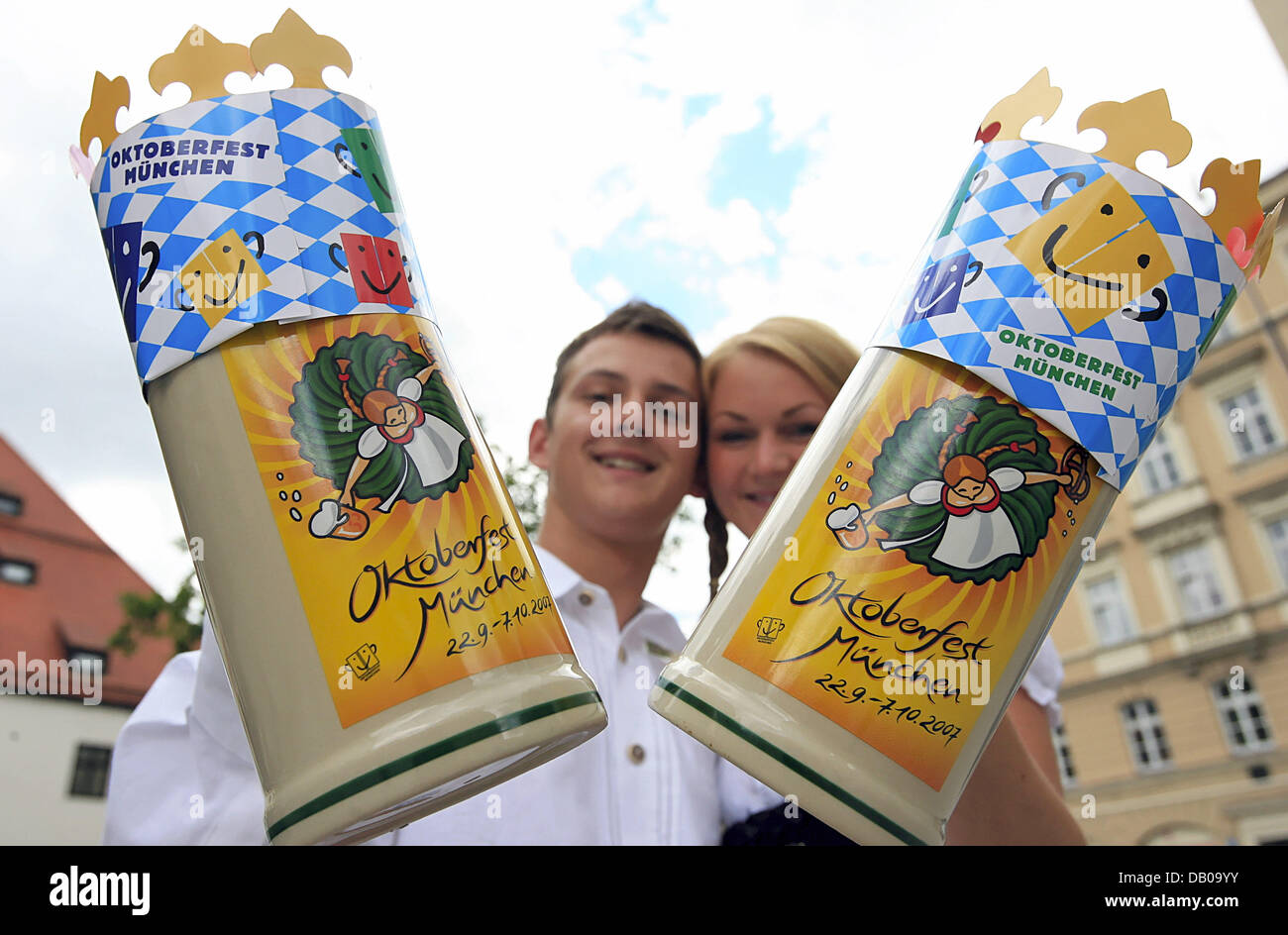 Alexandra Unger (R) and Maurice Franzl present the official beer mug ...