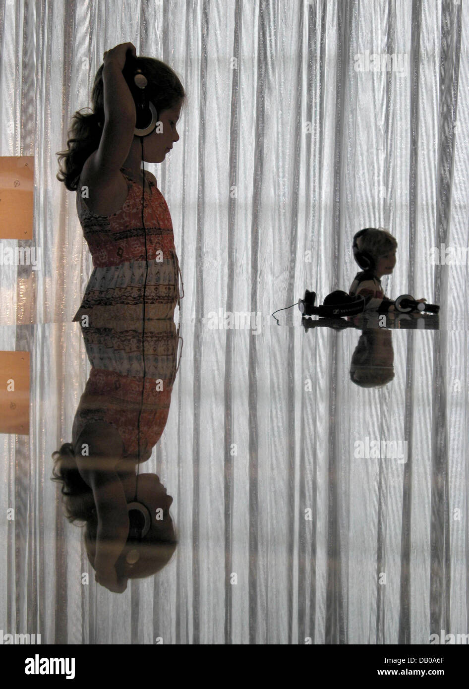 Children reflect in a glass display cabinet inside 'Aue-Pavillion' of ...