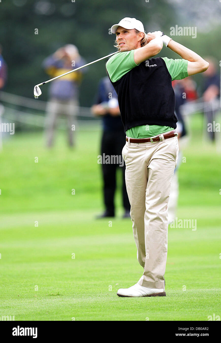The German golf player Tino Schuster observes the trajectory of his ...