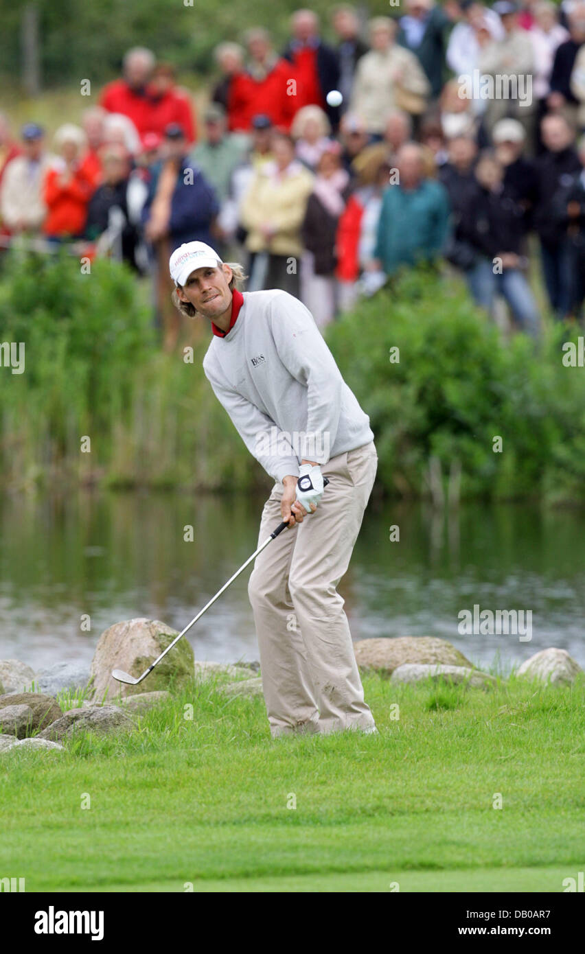 The German golf player Tino Schuster observes the trajectory of his ...