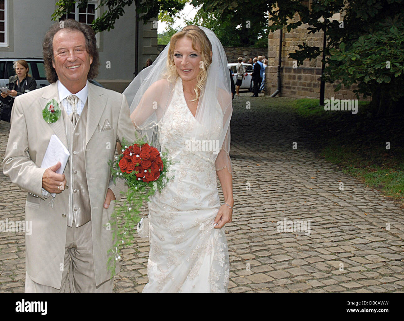 Singer Chris Andrews and his newly-wedded wife Alexandra Andrews smile ...