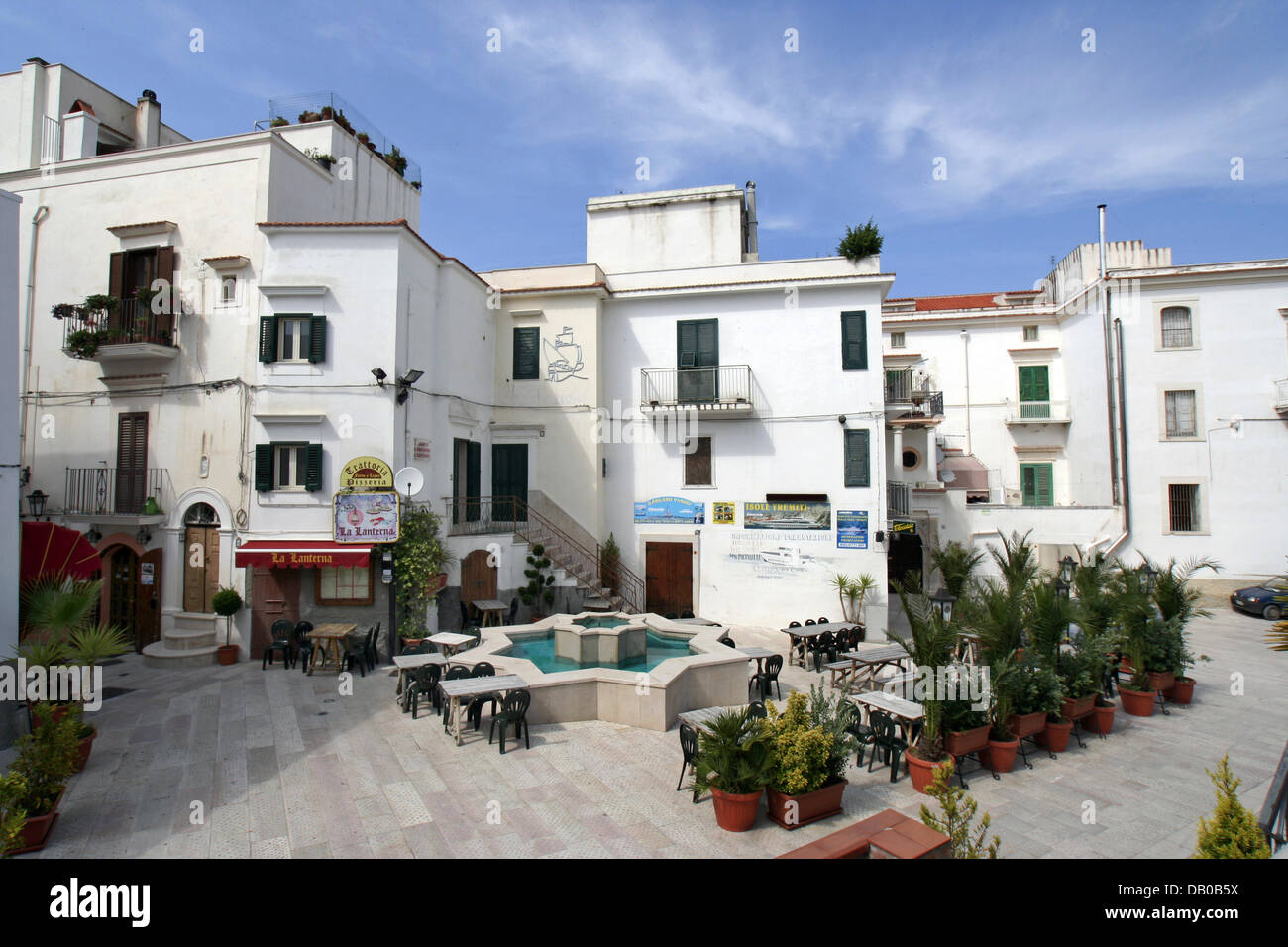The picture shows a beautiful plaza surrounded by whitewashed houses in ...