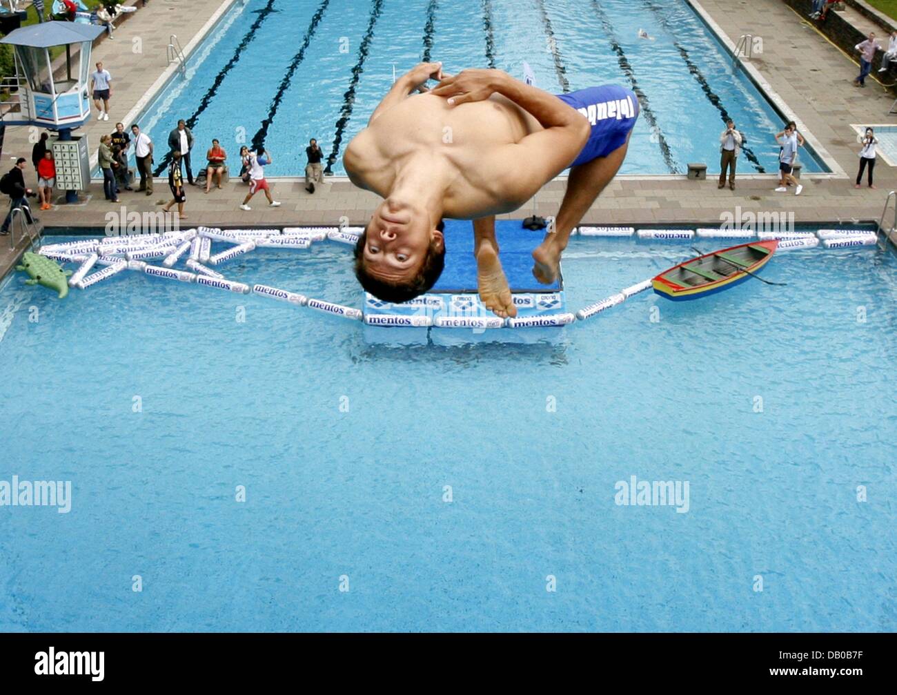 A participant of the Synchron competition jumps into the pool at the ...