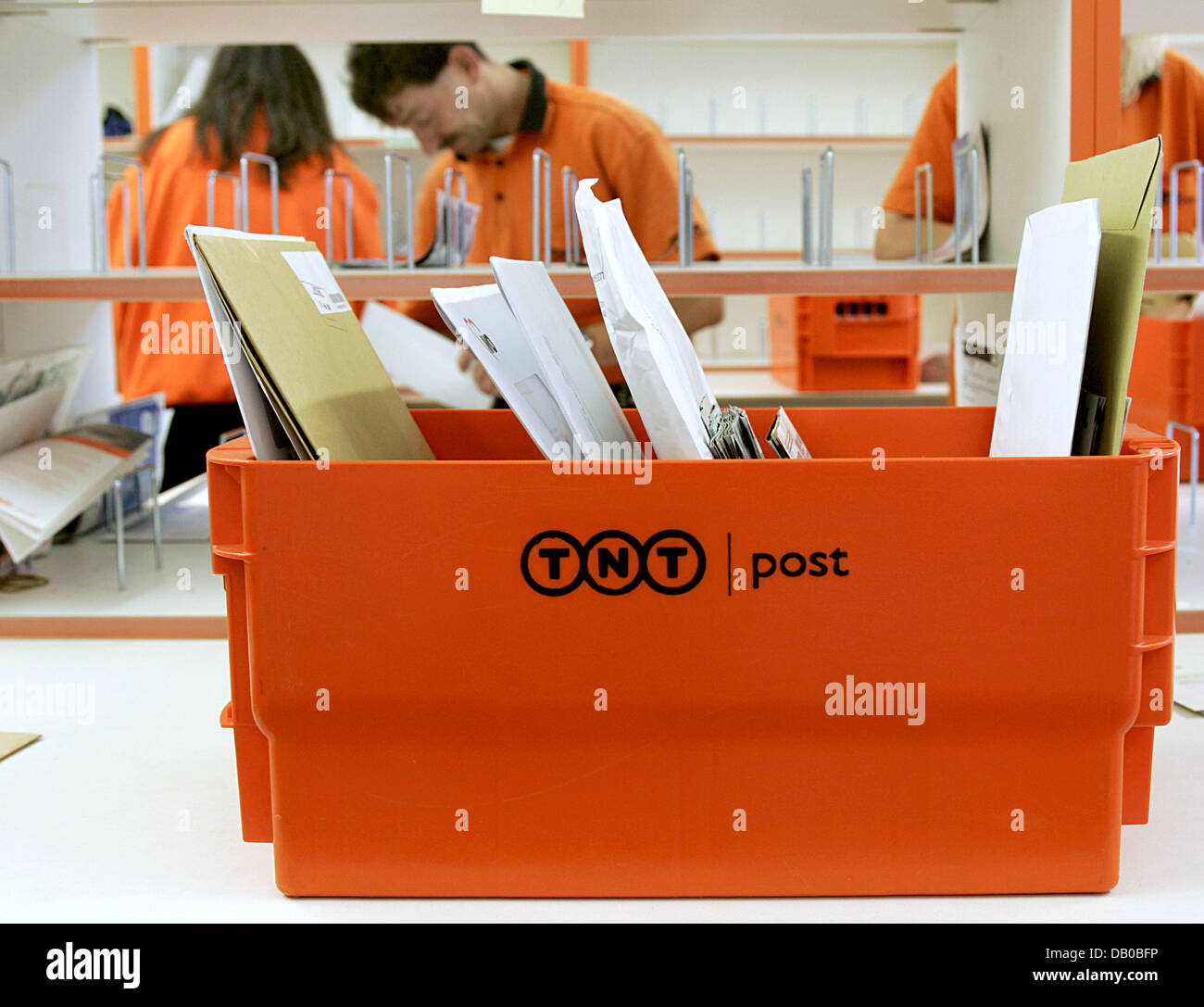Postmen of TNT Postal Service sort letters at their desks in Bochum ...