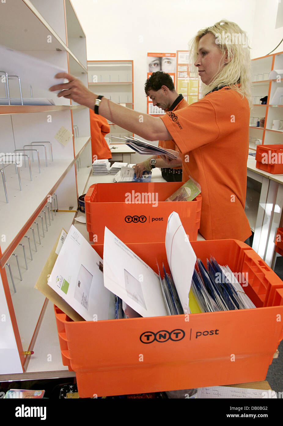 Postmen of TNT Postal Service sort letters at their desks in Bochum ...