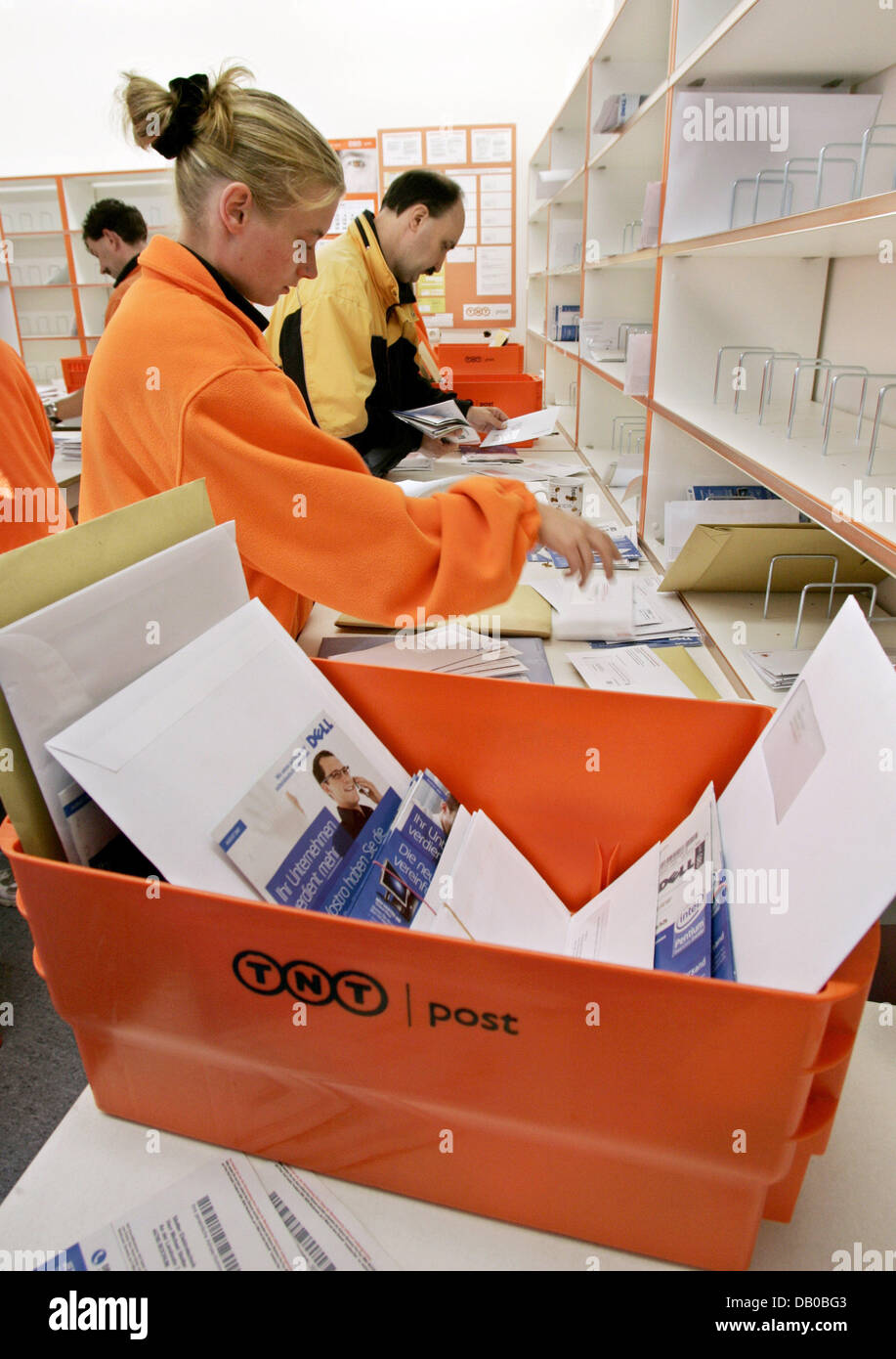 Postmen of TNT Postal Service sort letters at their desks in Bochum ...