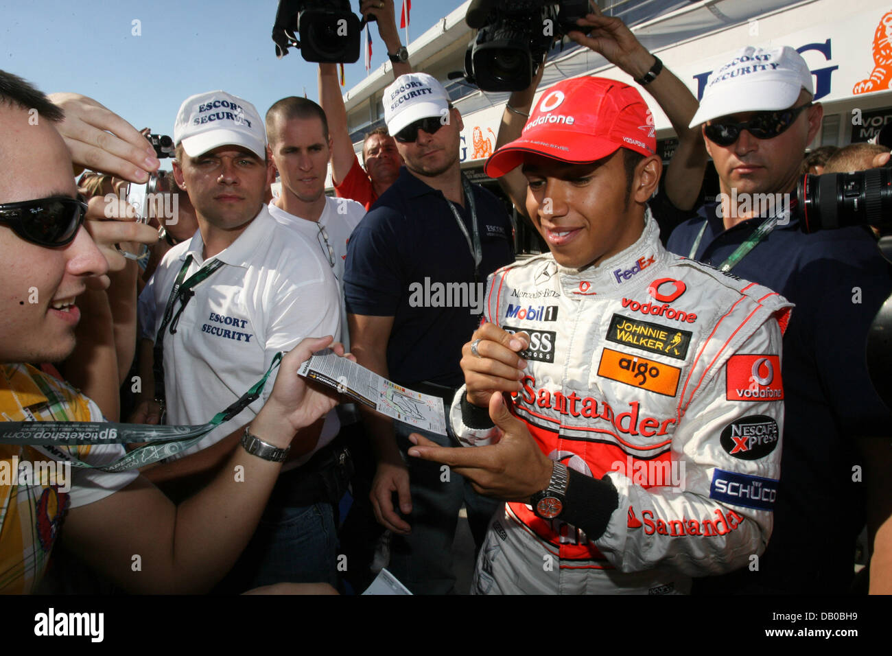 Britsh Formula One driver Lewis Hamilton of McLaren Mercedes signs ...