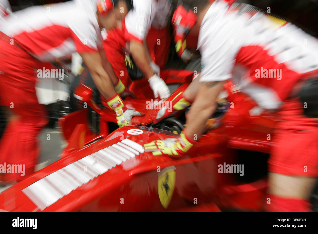 Mechanics of Scuderia Ferrari work on the race car of Brazilian Formula ...