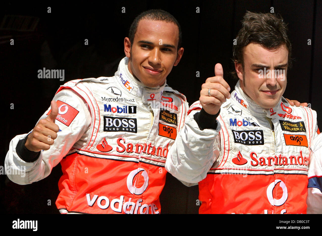 Spanish Formula One pilot Fernando Alonso (R) of McLaren Mercedes and ...