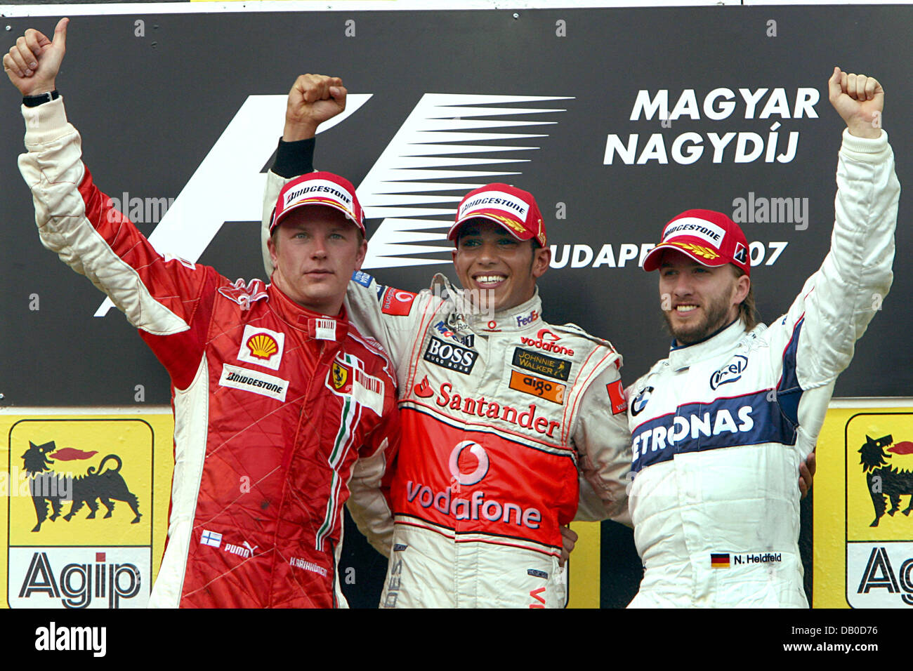 The British winner Lewis Hamilton (C) of McLaren Mercedes cheers with ...