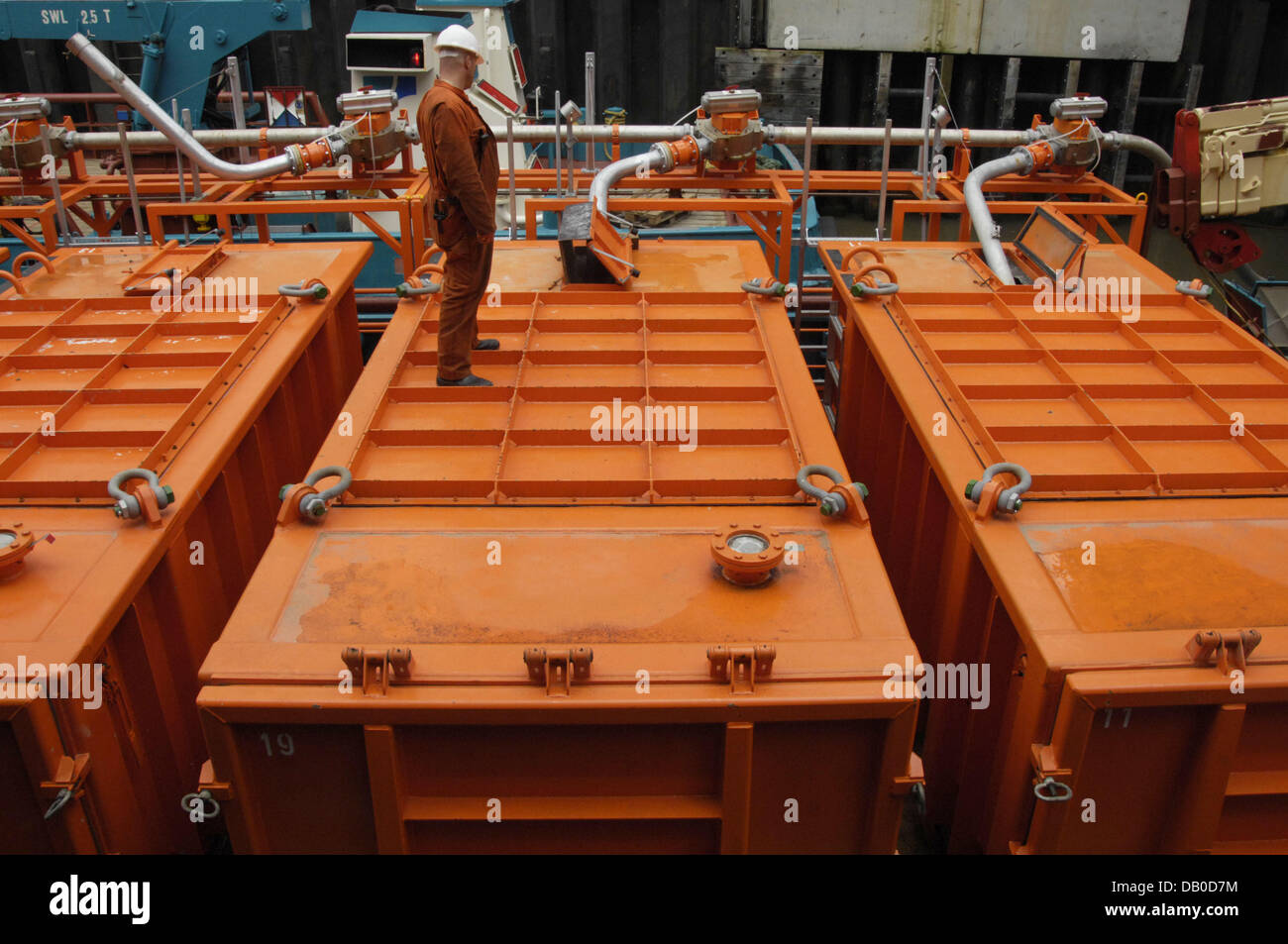 A worker checks the feed pipes on a special ship with pressure ...