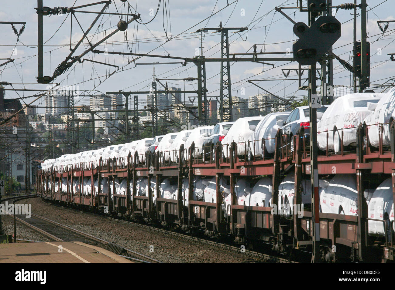 A freight train with brand new cars pictured passing the station of ...