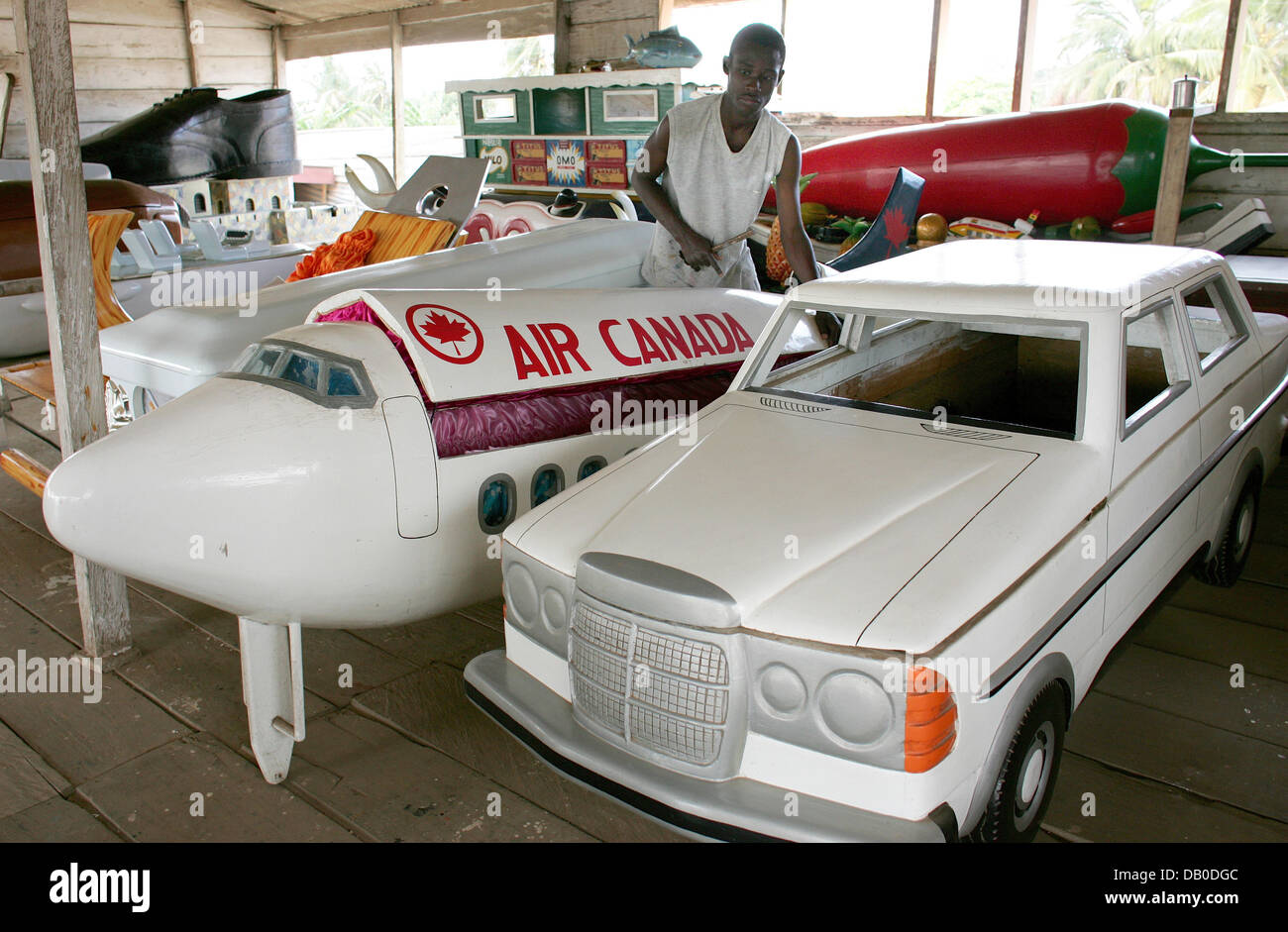 A coffin maker shows the extravagant coffins on display at the workshop ...