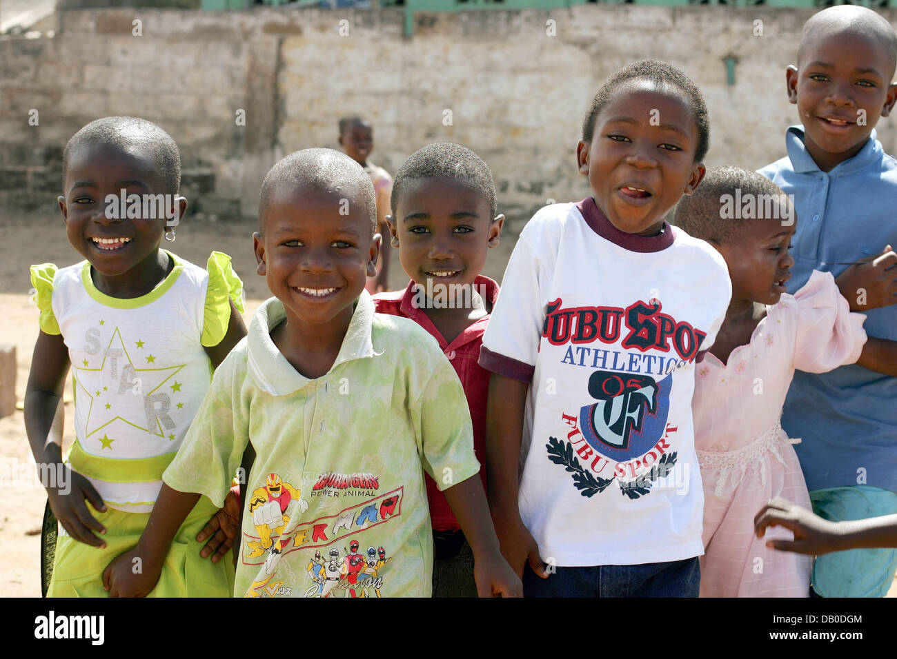 A group of young boys and girls smiles at a schoolyard in Accra, Ghana ...