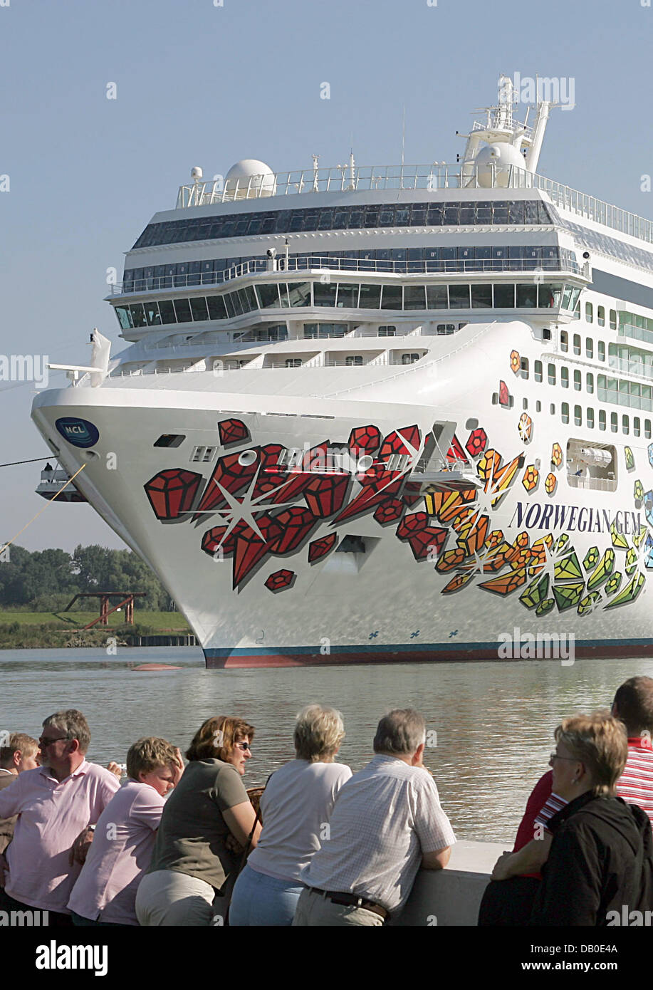 People observe the new cruise ship 'Norwegian Gem' undock at the Meyer ...