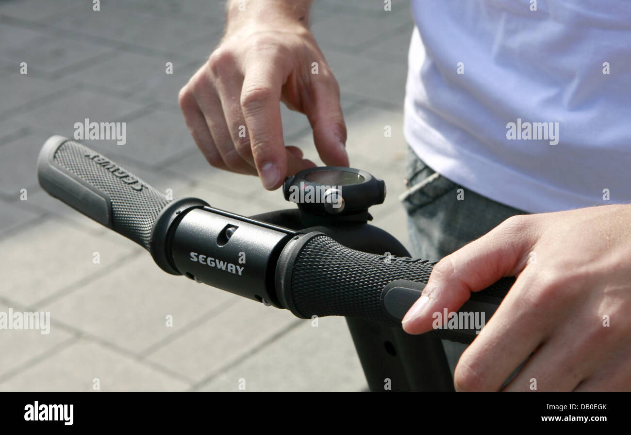A man operates a mini-computer on a segway's handlebar in Munich ...