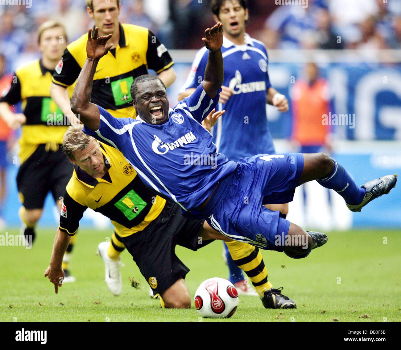 Schalke's Gerald Asamoah (R) and Dortmund's Christian Woerns vie for ...