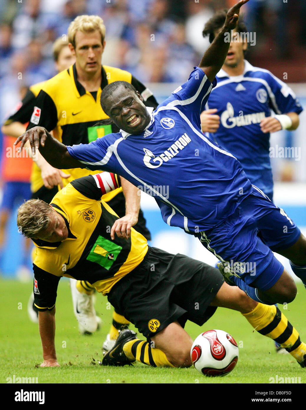 Schalke's Gerald Asamoah (R) and Dortmund's Christian Woerns vie for ...