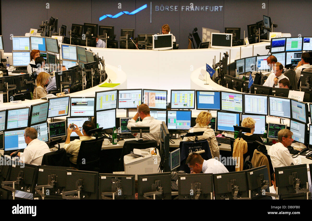 Brokers observe market trends on their monitors at the Stock Exchange ...