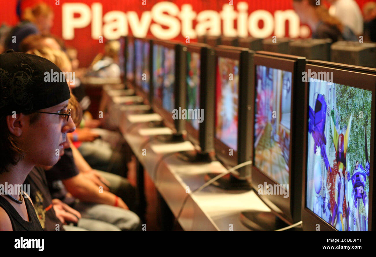 Visitors play computer games at the Sony stand of Europe's biggest ...