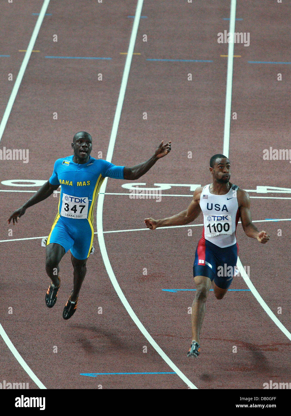 US American sprinter Tyson Gay (R) crosses the finish line to win the ...