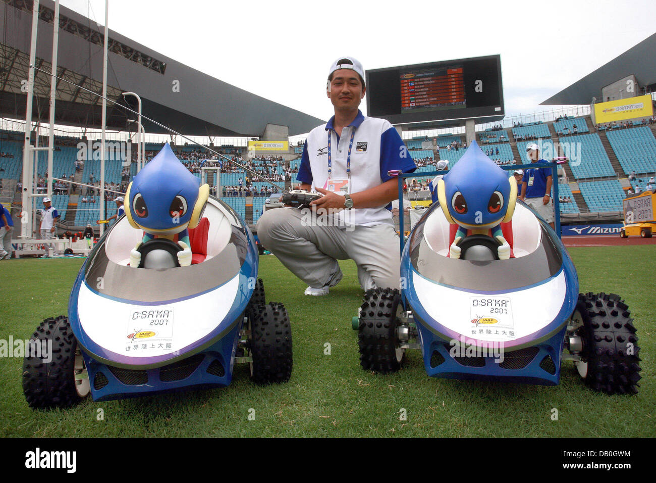 Japanese Keiji Watanabe smiles with robot transporters bringing home ...