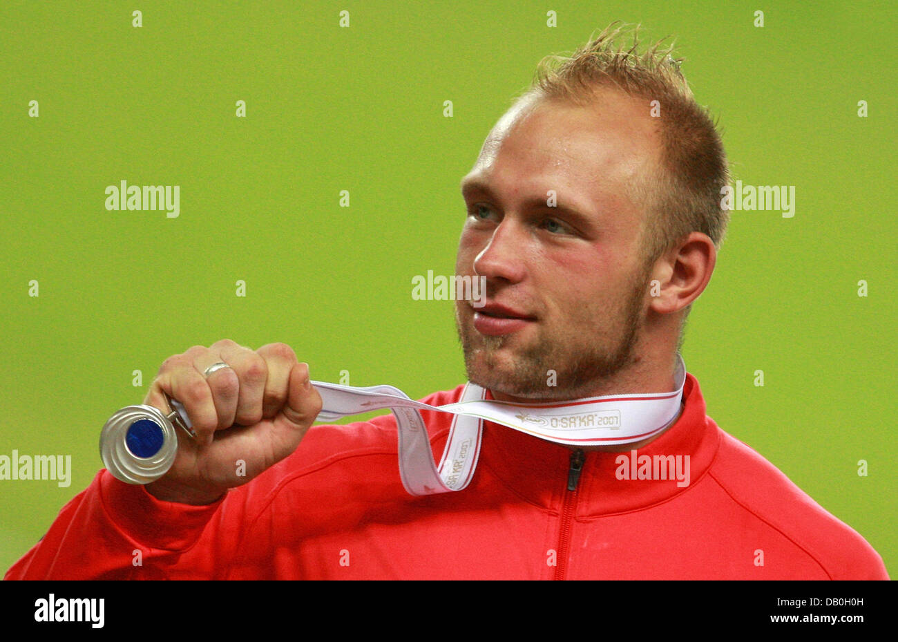 German Robert Harting celebrates his silver medal for the Men Discus ...