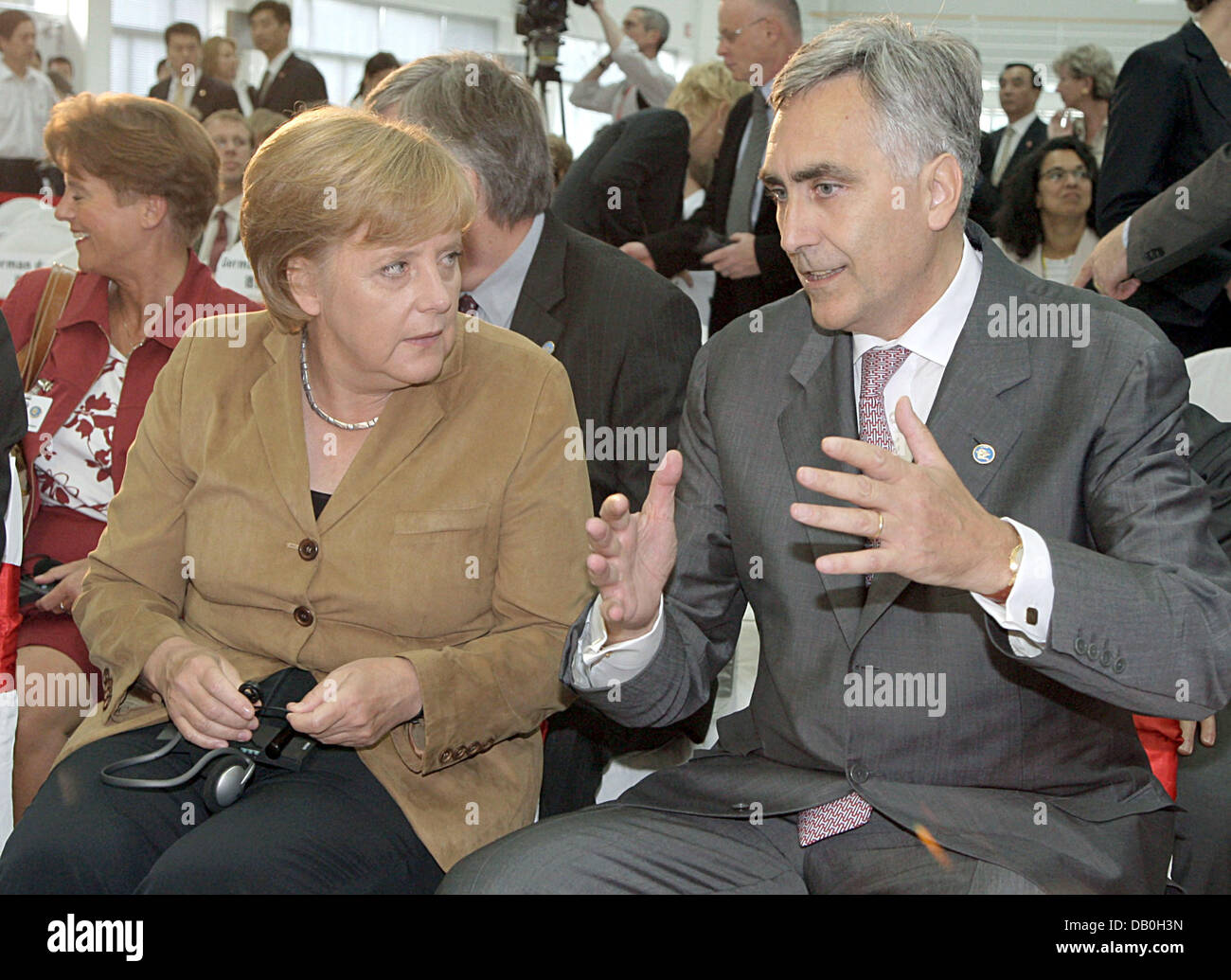 German Chancellor Angela Merkel (L) and Peter Loescher CEO of Siemens ...
