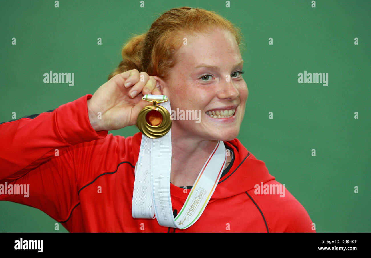 German hammer thrower Betty Heidler poses with her gold medal won at ...
