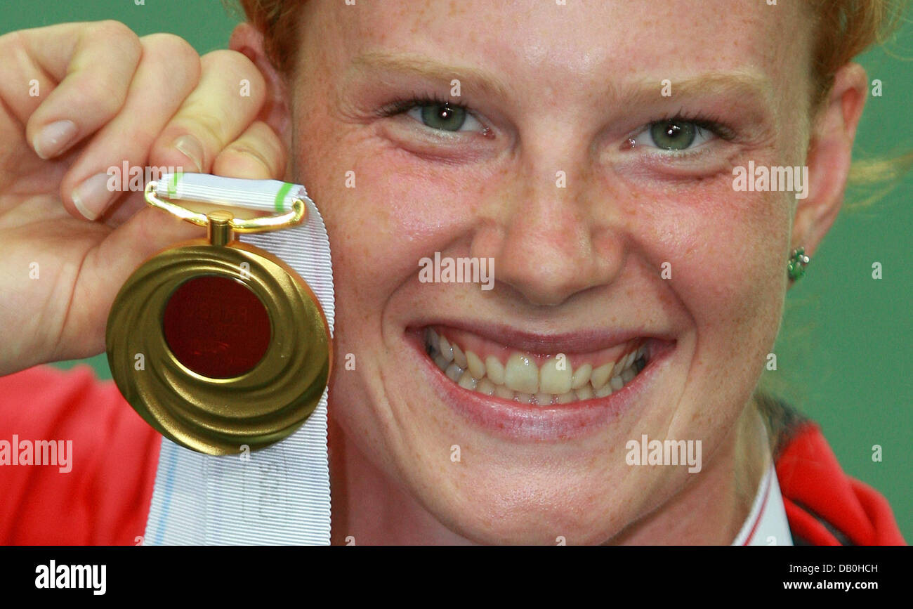 German hammer thrower Betty Heidler poses with her gold medal, won at ...
