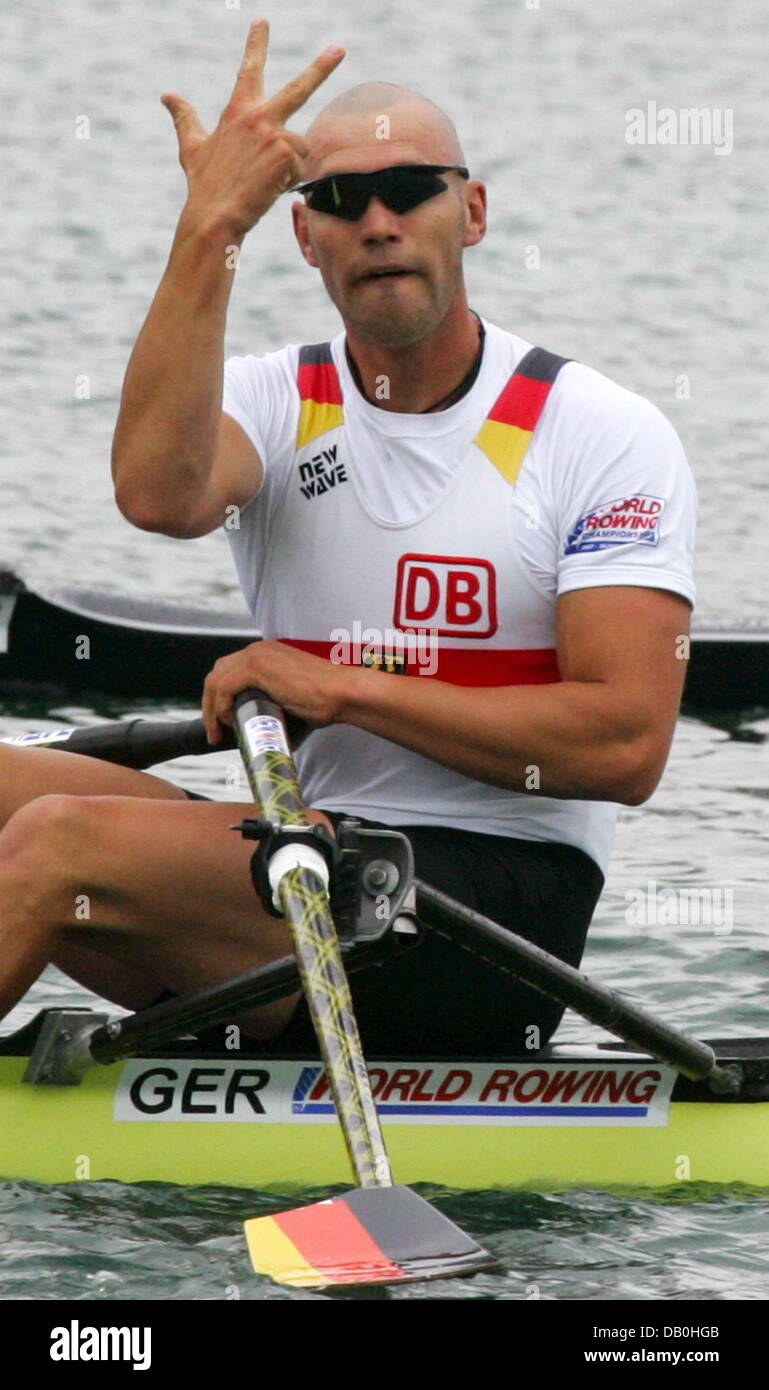 German single scull rower Marcell Hacker gestures with three fingers ...