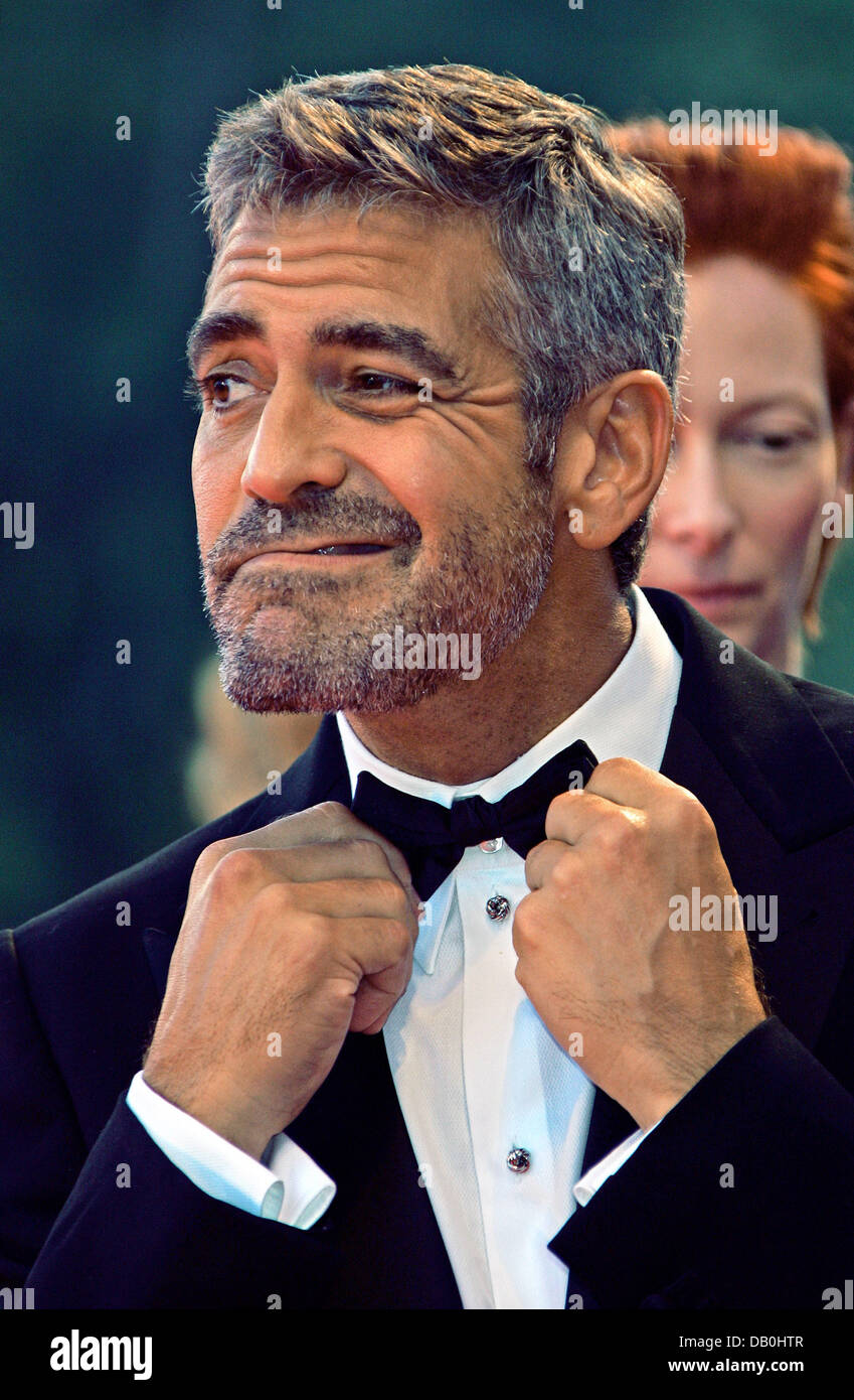 US actor George Clooney poses for a photo on the red carpet prior to ...