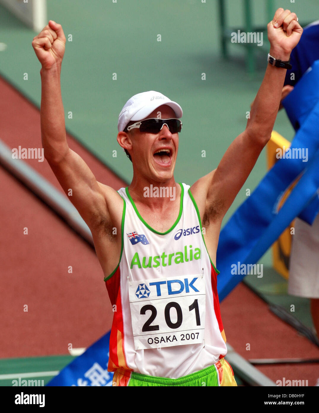 Nathan Deakes of Australia celebrates crossing the finish line first ...
