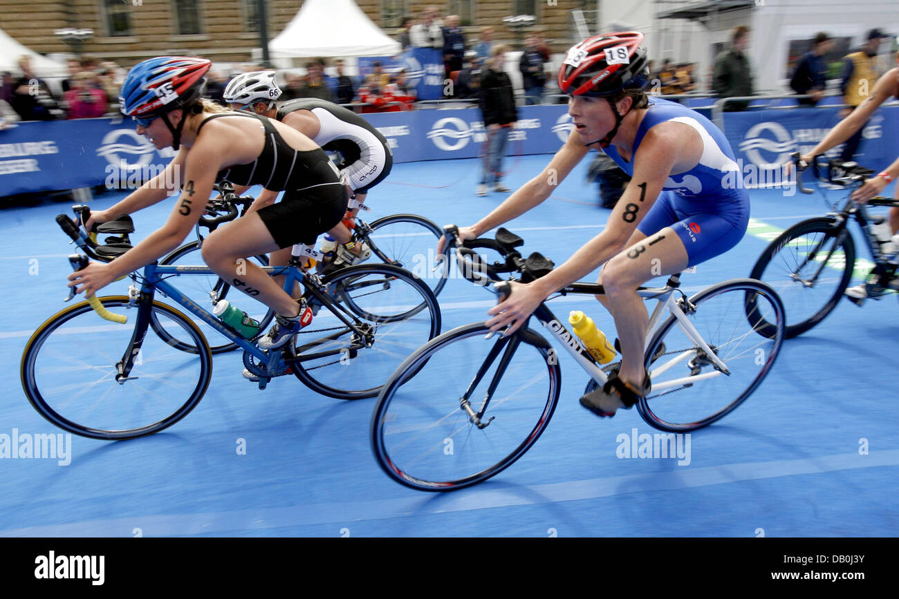 Triathletes cycle past the city hall during the Hamburg Triathlon World ...