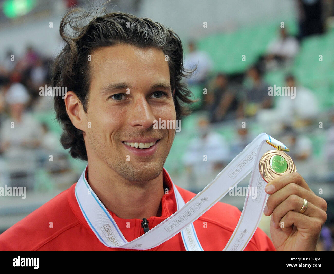 German Danny Ecker poses with his bronze medal won in the Pole Vault ...