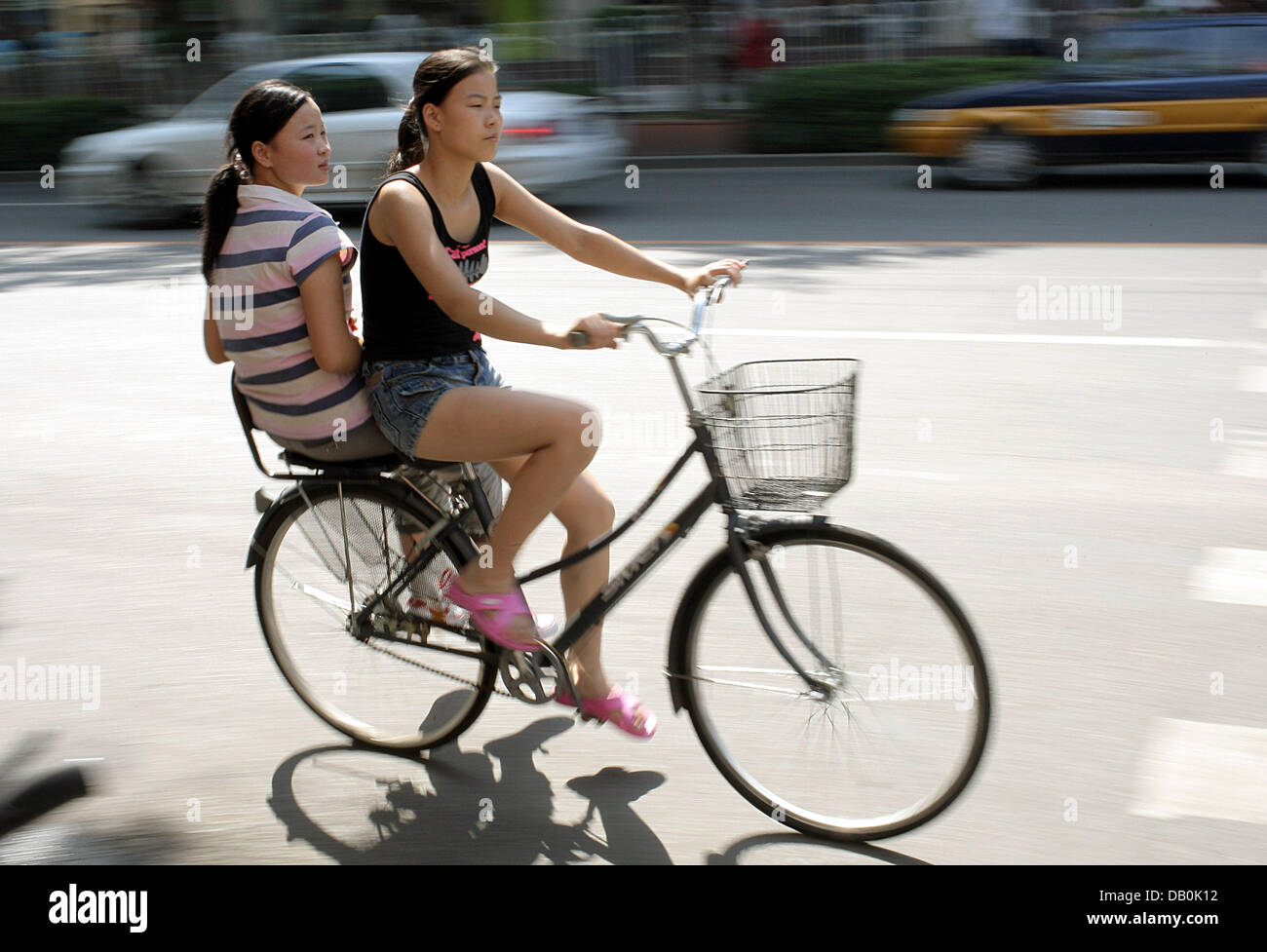 Two Chinese girls shown on their bike in Beijing, China, 27 August 2007 ...