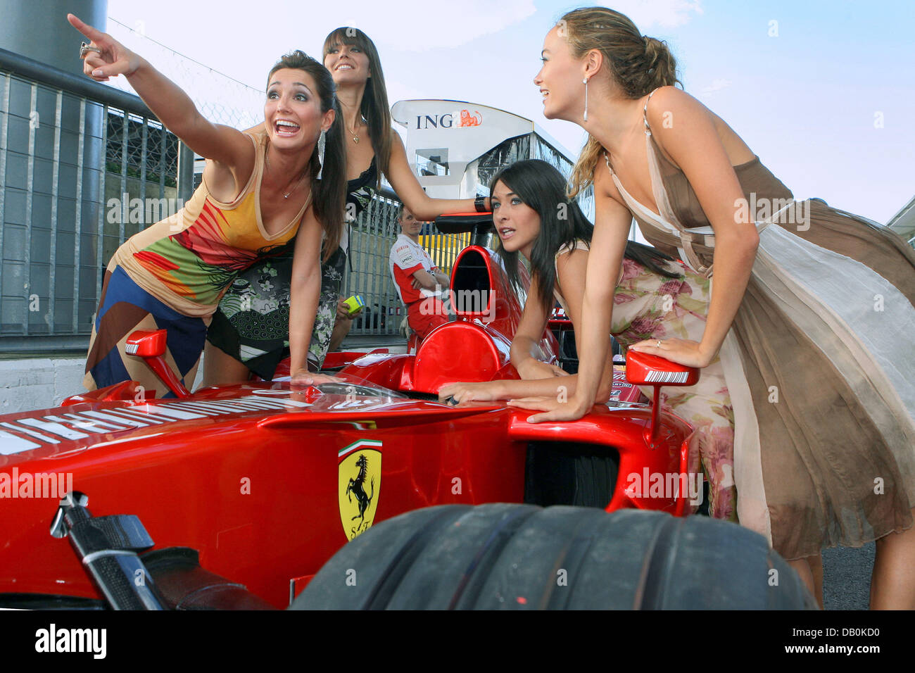 Model pose on a Ferrari racingcar at the Italian Formula One Gran Prix ...