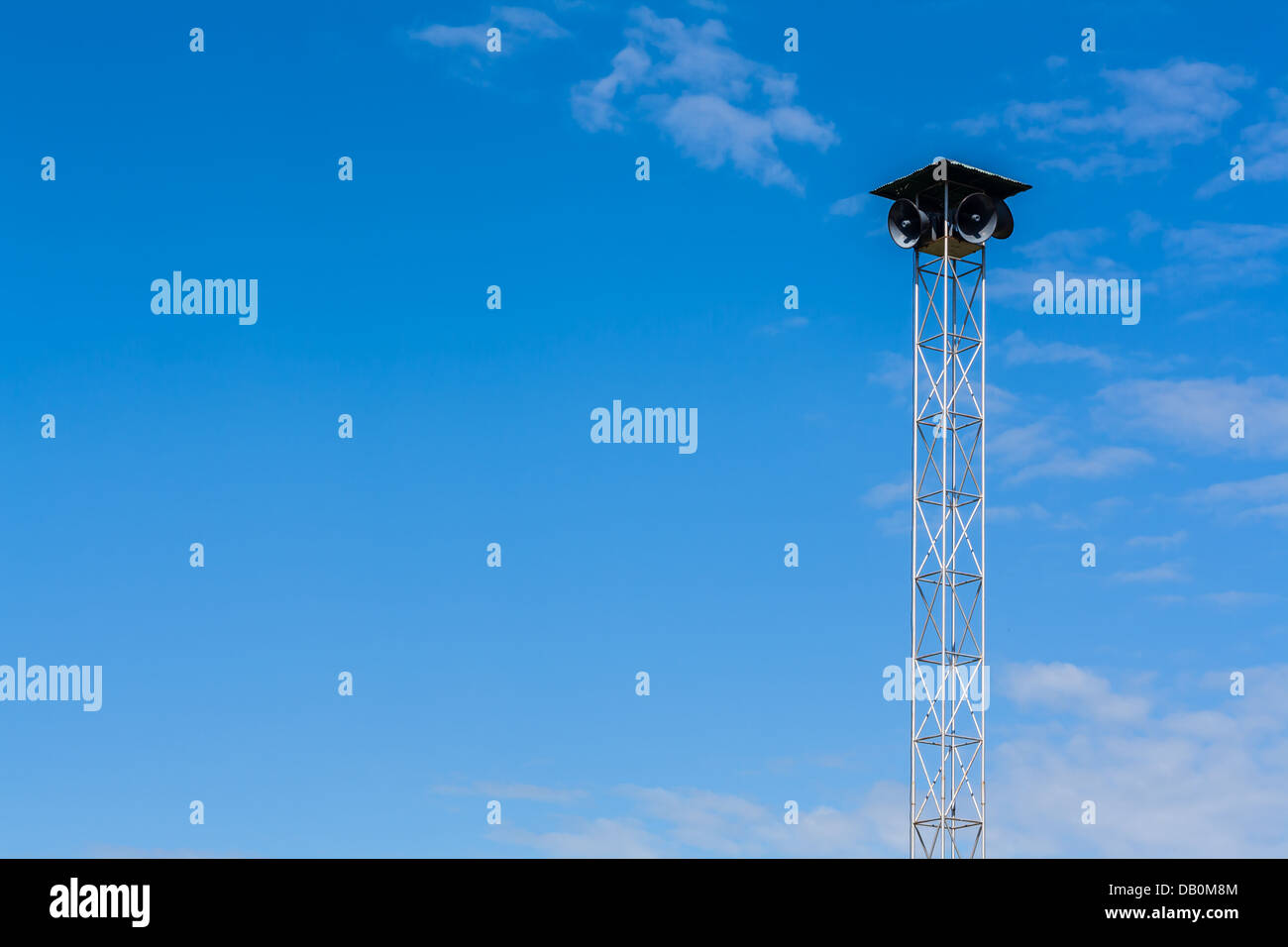 Speakers on the metal pole tower for announcement with blue sky ...