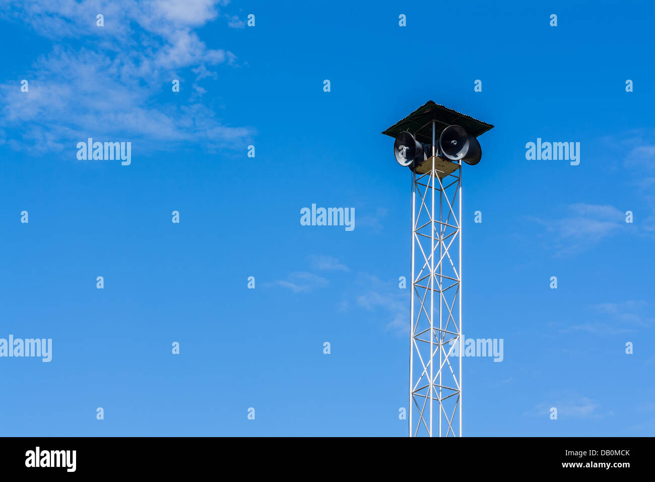 Speakers on the metal pole tower for announcement with blue sky ...