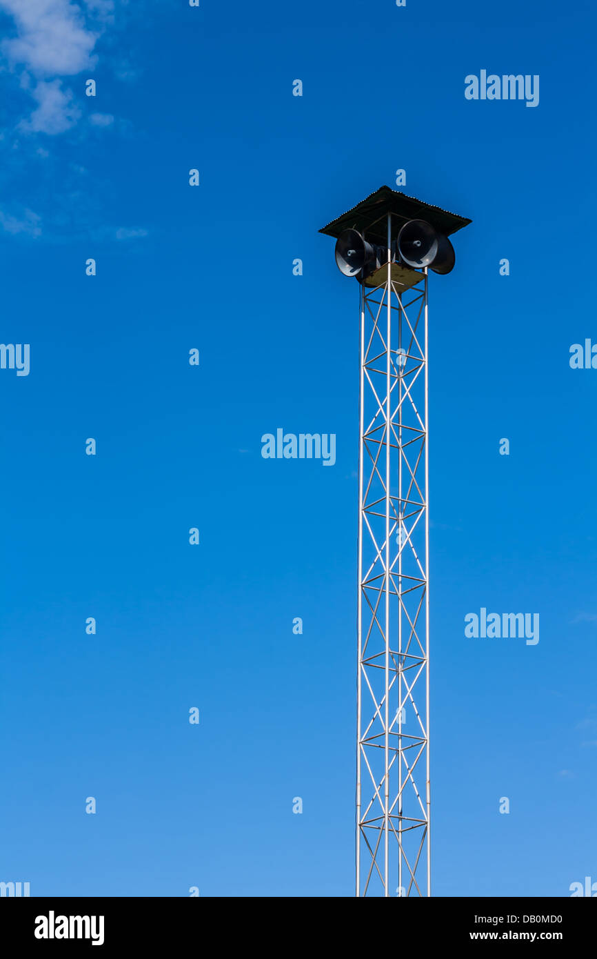 Speakers on the metal pole tower for announcement with blue sky ...