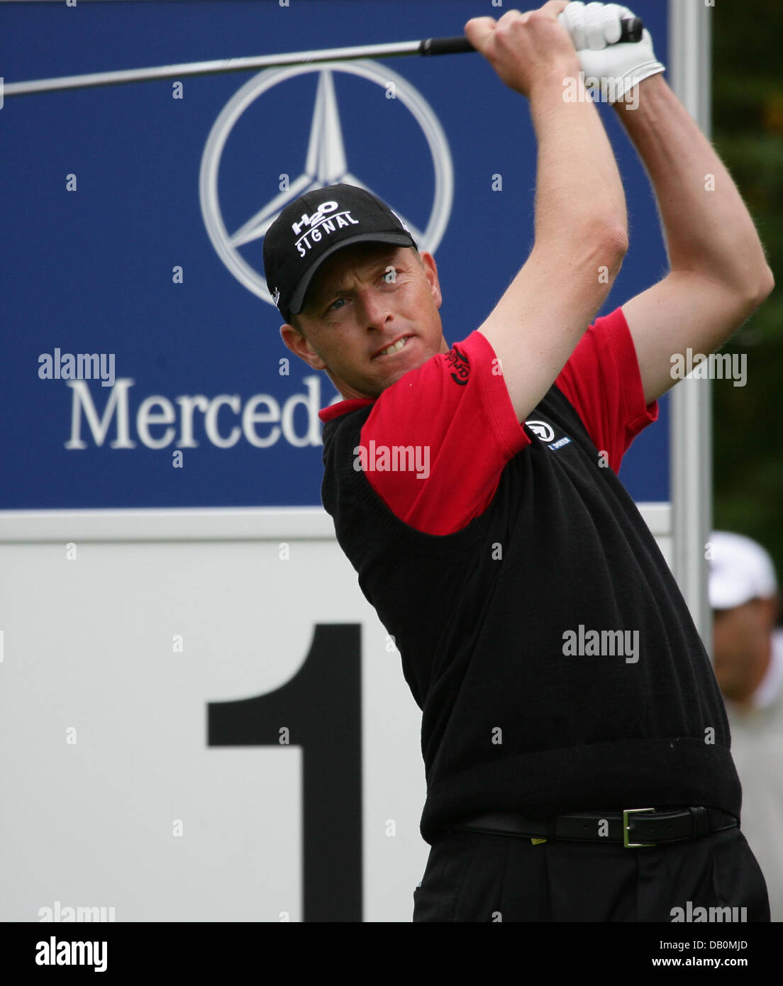 Danish golfer Soeren Hansen grimaces as he hits the ball at the ...