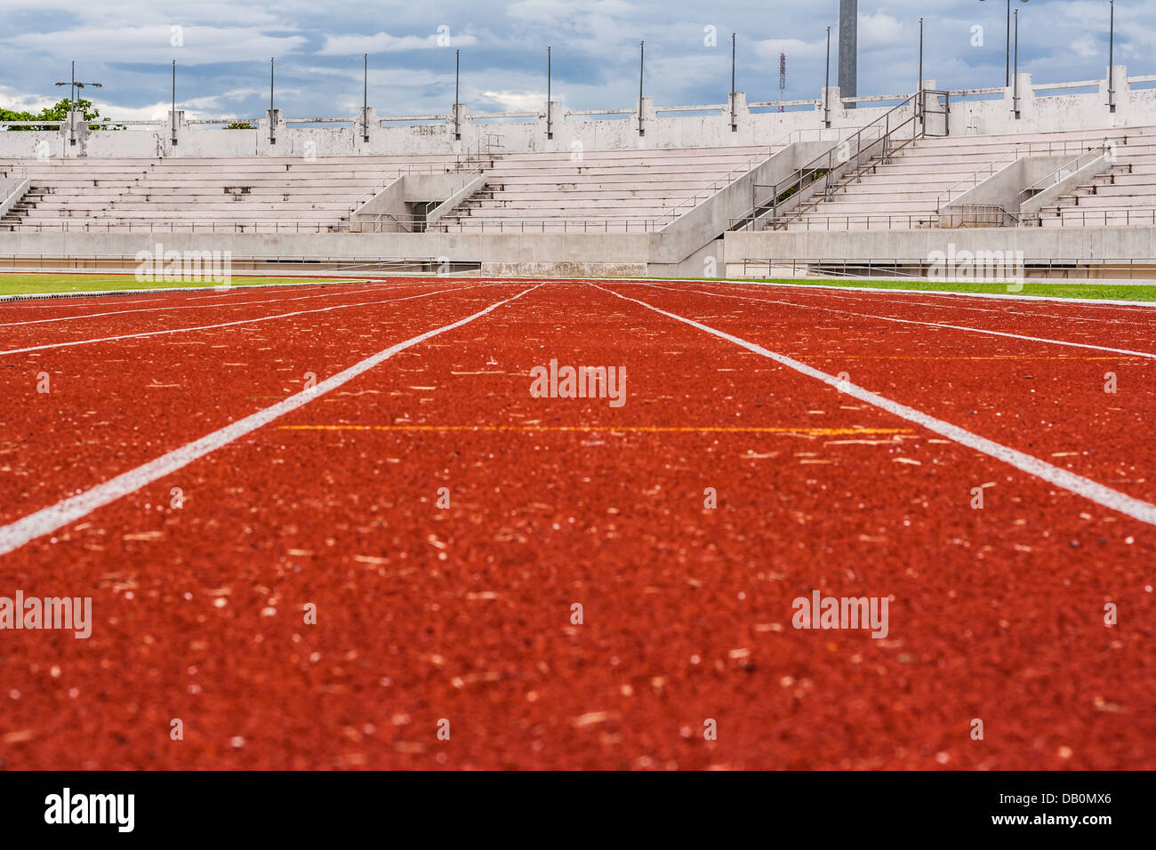 Blank orange track in the stadium (runway) on the side of football ...