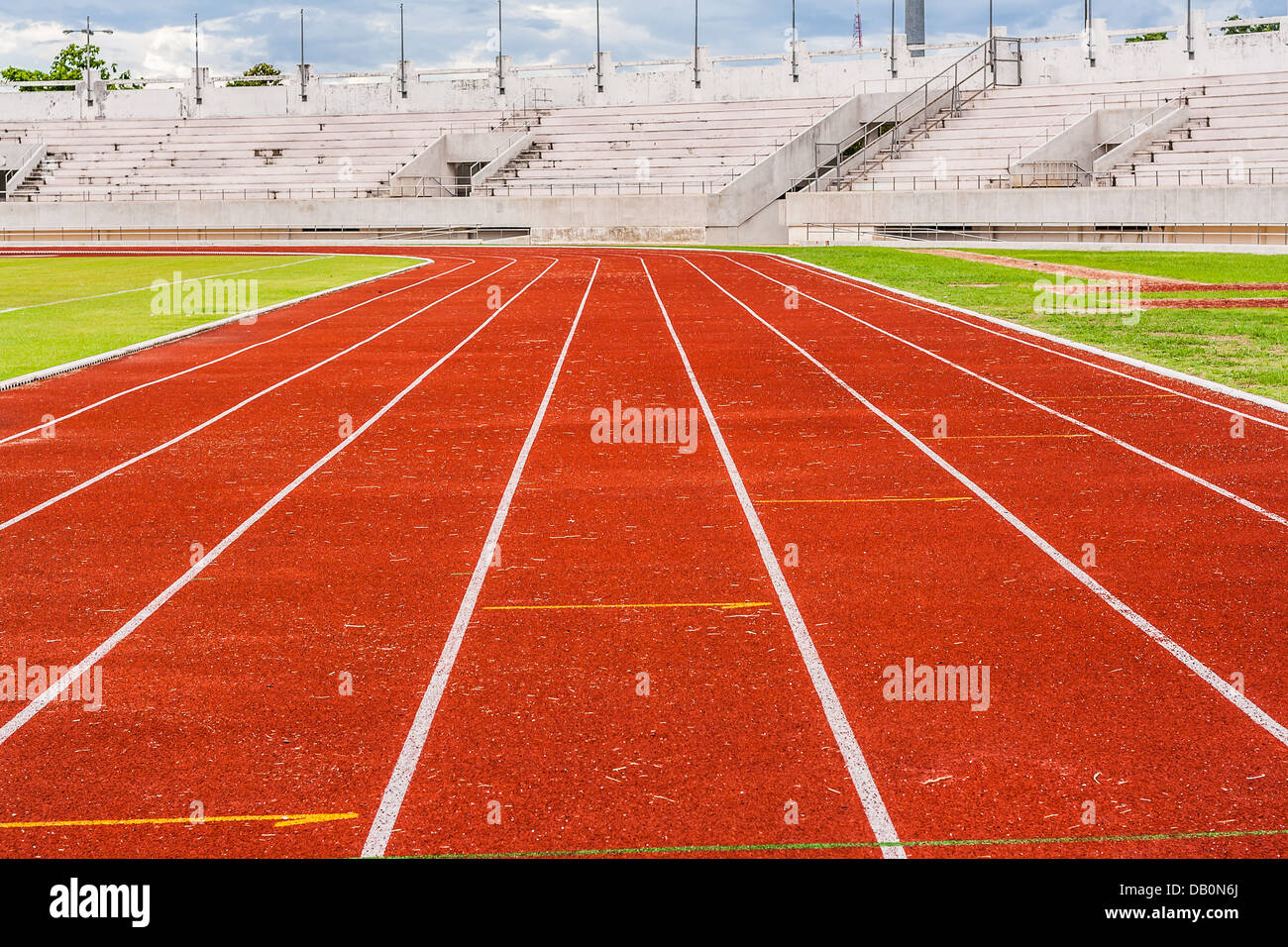 Blank orange track in the stadium (runway) on the side of football ...