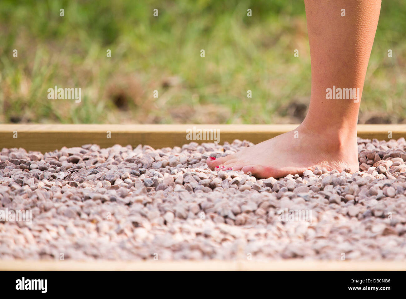 Bristol, UK. 22nd July, 2013. A woman walks through the Barefoot Trail ...
