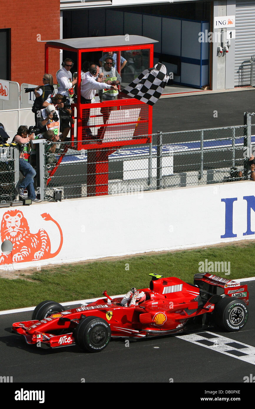 Finnish Formula One driver Kimi Raikkonen of Ferrari crosses the finish ...