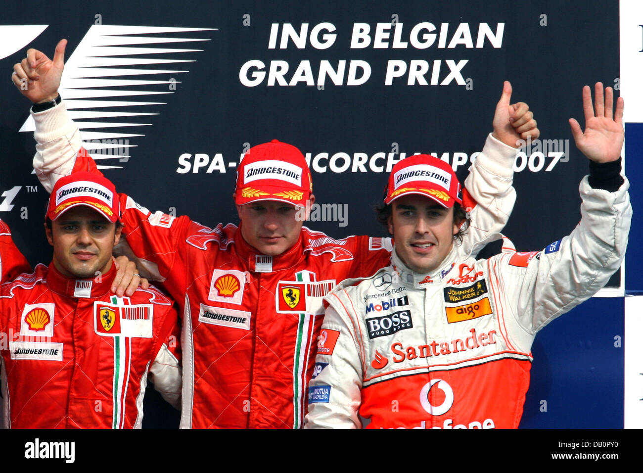 Finnish Formula One driver Kimi Raikkonen of Ferrari (C) cheers with ...
