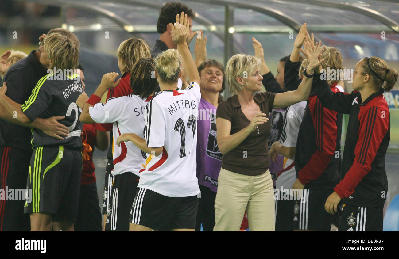 Germany's national coach Silvia Neid (C) high fives the team's members ...