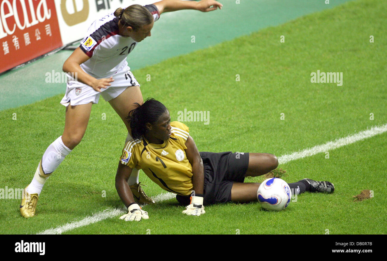 USA's Abby Wambach (L) and Nigeria's goalkeeper Precious Dede vie for ...