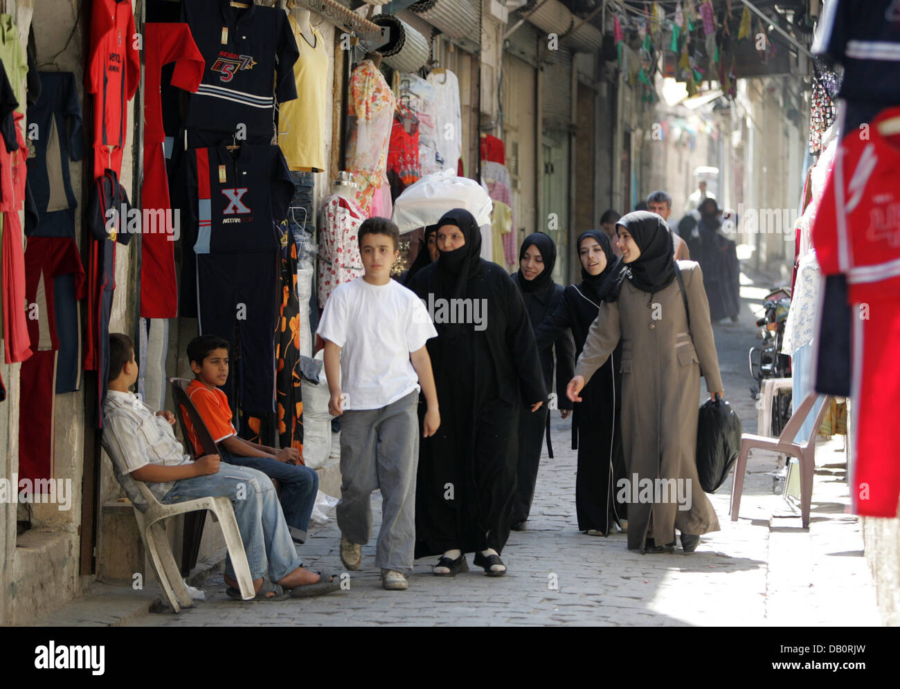The picture shows people walking in a street at the historic city ...