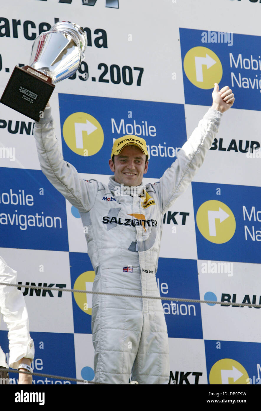 The pilot of the German Touring Car Masters DTM Jamie Green cheers ...